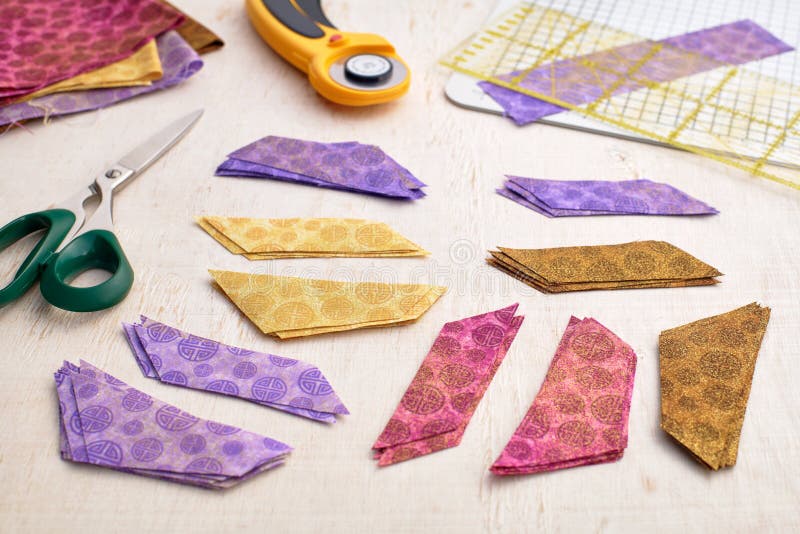 Stacks of Multi-colored Pieces of Fabric, Scissors, Rotary Cutter ...