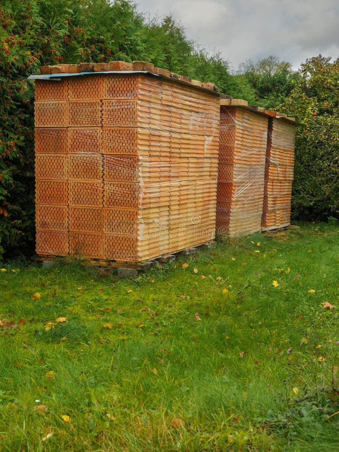 Stacks of Orange Bricks Wrapped in Plastic and Covered for Protection ...