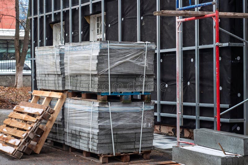 Wrapped Paving Stones are Stacked on Pallets at a Construction Site ...
