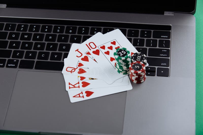 Stacks of Poker Chips and Playing Cards on a Laptop Computer. Casino ...