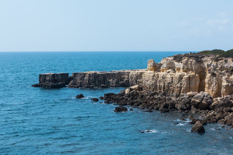 Stacks and Rock Cliffs at a Shore Under a Bright Sky Stock Photo ...