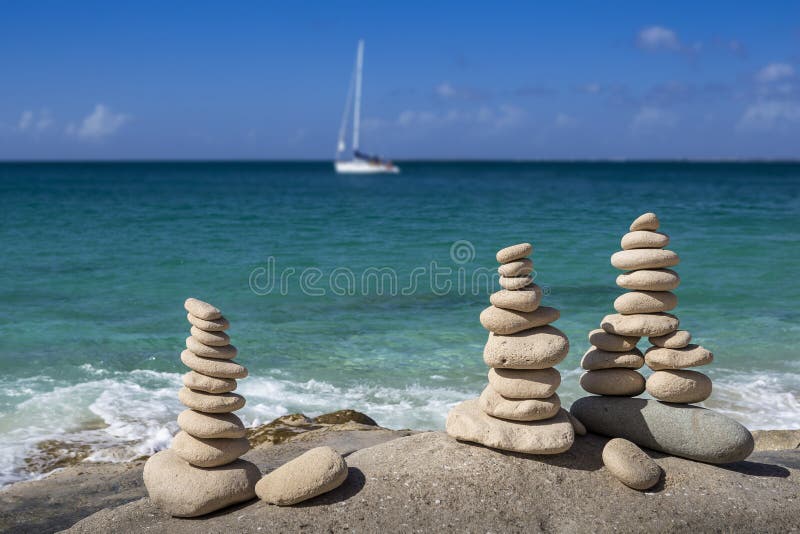 Stacks of Stones in Balance at a Beach with Yacht on Background Stock ...