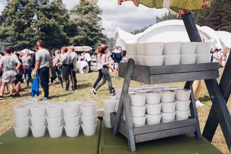 Soup in Containers on Table.Stacks of White Plastic Containers of Red ...