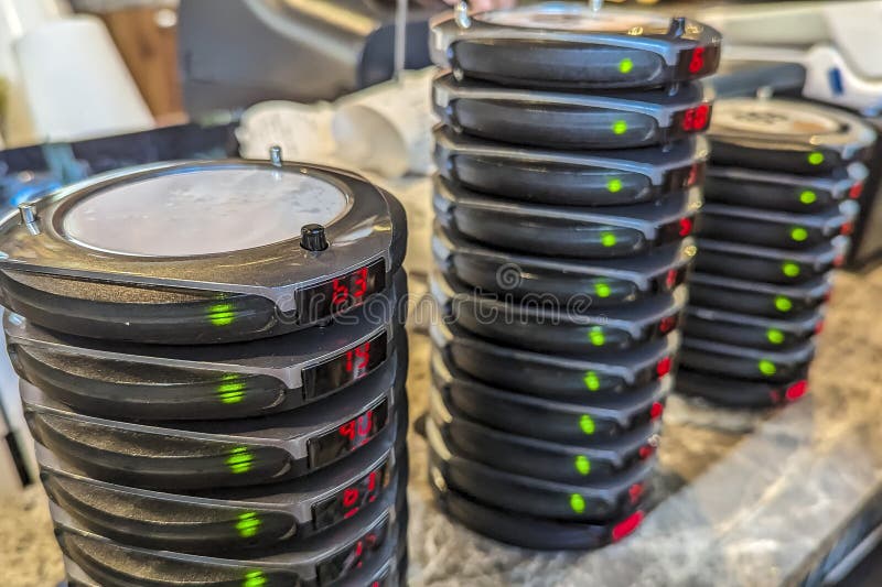 Stacks of Wireless Restaurant Pager, Buzzers or Beepers at the Counter ...