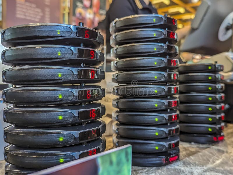 Stacks of Wireless Restaurant Pager, Buzzers or Beepers at the Counter ...