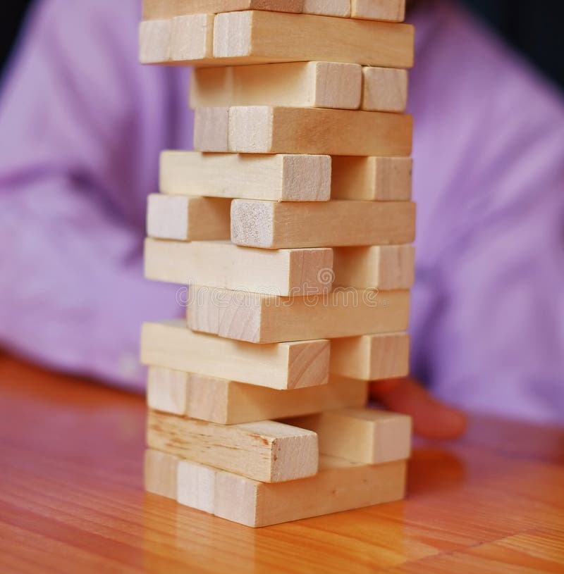 Stacks of Wooden Blocks on a Wooden Table with Player in the Background ...