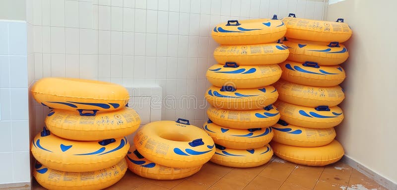 Stacks of Yellow Water Tubes, Lying Near a Light Tiled Wall Stock Photo ...