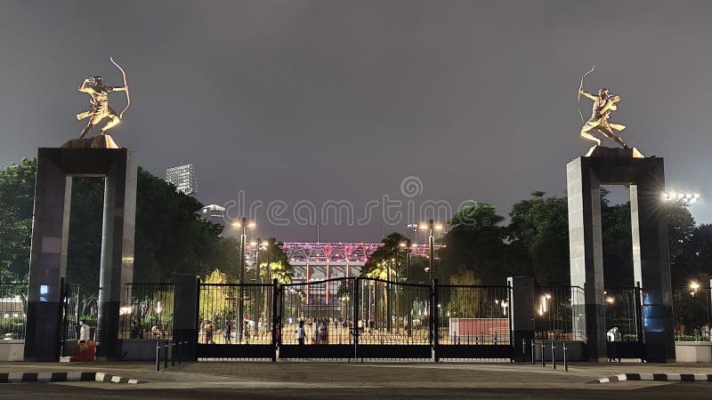 Stadium Gate in Jakarta at Night with Two Legendary Archer Statues ...