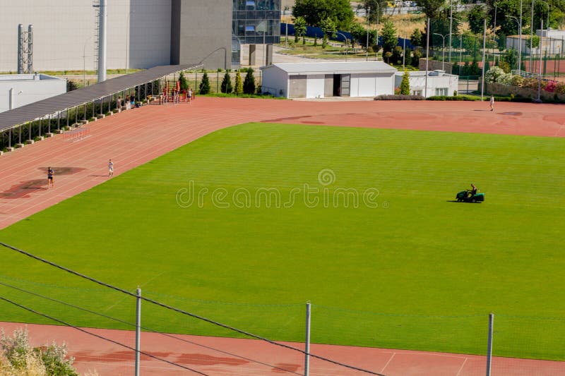Stadium with Green Grass and Lawn Mower Machine Stock Photo - Image of ...