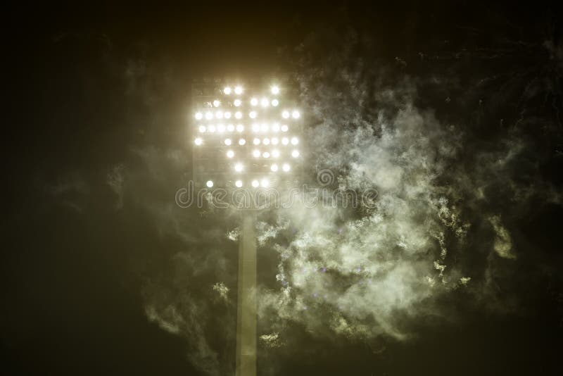 Stadium lights and smoke stock photo. Image of leisure - 61026476