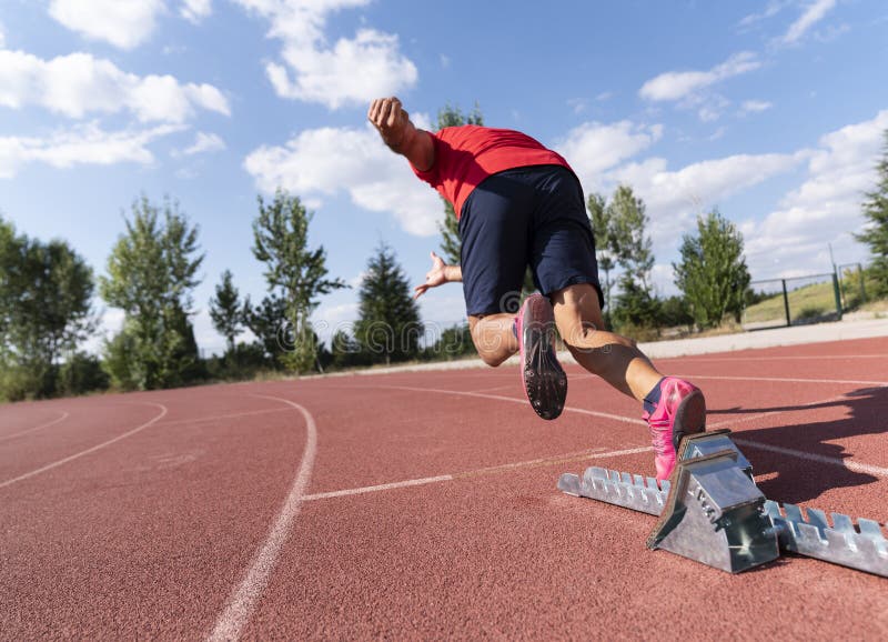 Man Running and Start Block of Athlete on a Runner and Arena Track for ...