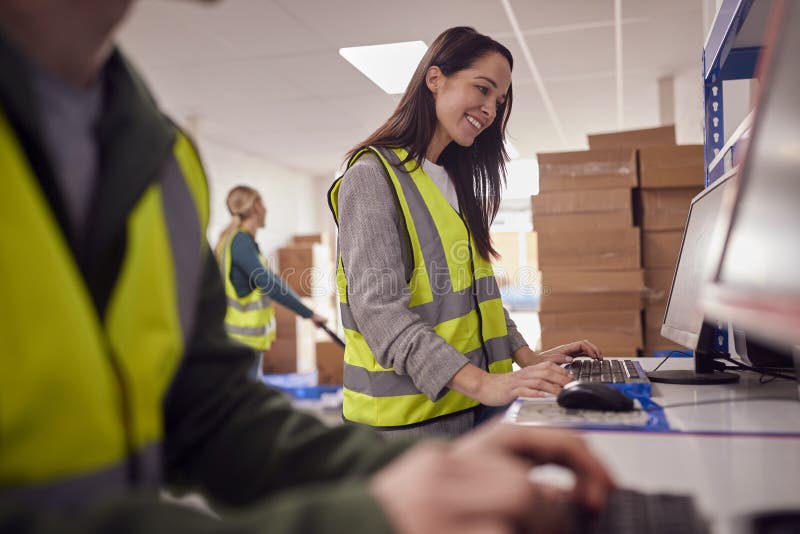 Staff in Busy Modern Warehouse Working on Computer Terminals Stock ...