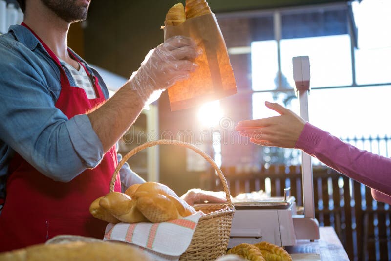 Staff Giving Packet Bread To Customer Stock Photo - Image of buyer ...