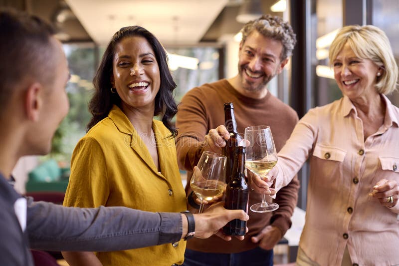 Staff at Informal Team Meeting in Office Celebrating with Drinks Stock ...