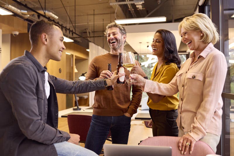 Staff at Informal Team Meeting in Office Celebrating with Drinks Stock ...