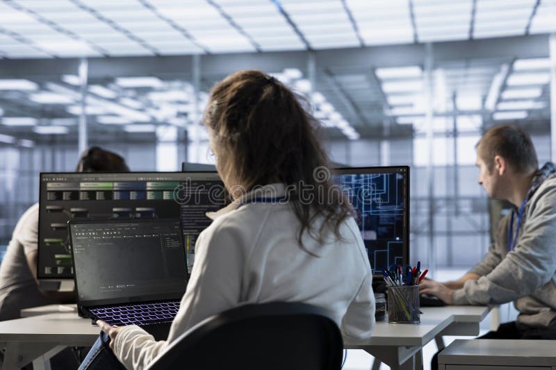 Woman Running Code on Laptop To Upgrade Artificial Intelligence Rigs ...