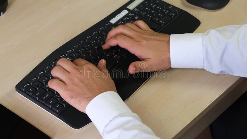 A Staff Member is Typing on the Keyboard and Using the Keyboard S ...