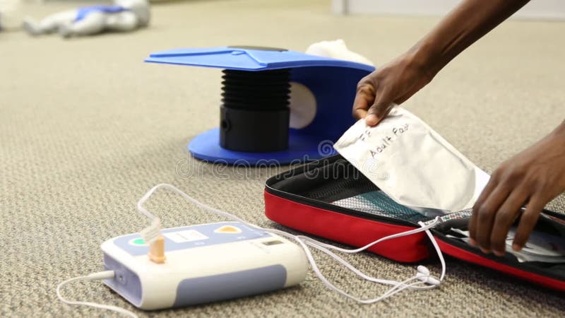 Staff Practicing First Aid Cpr with AED Machine and Dummy Dolls Stock ...
