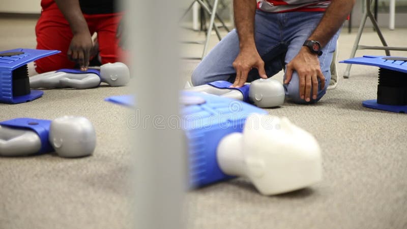 Staff Practicing First Aid Cpr with AED Machine and Dummy Dolls Stock ...