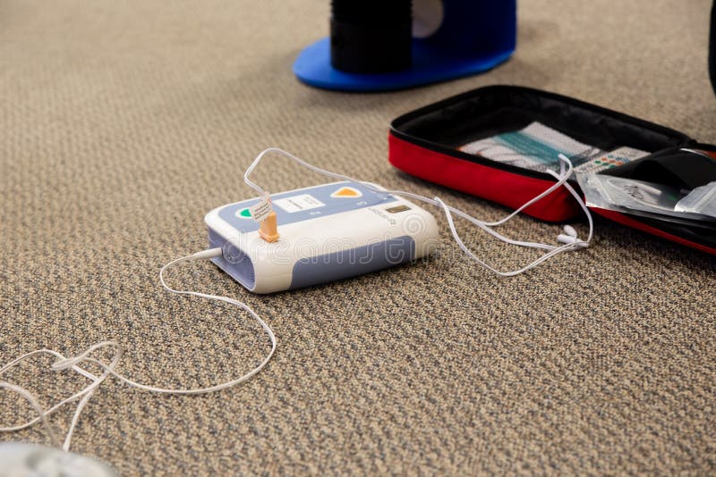 Staff Setting AED Machine To Practice First Aid Stock Photo - Image of ...