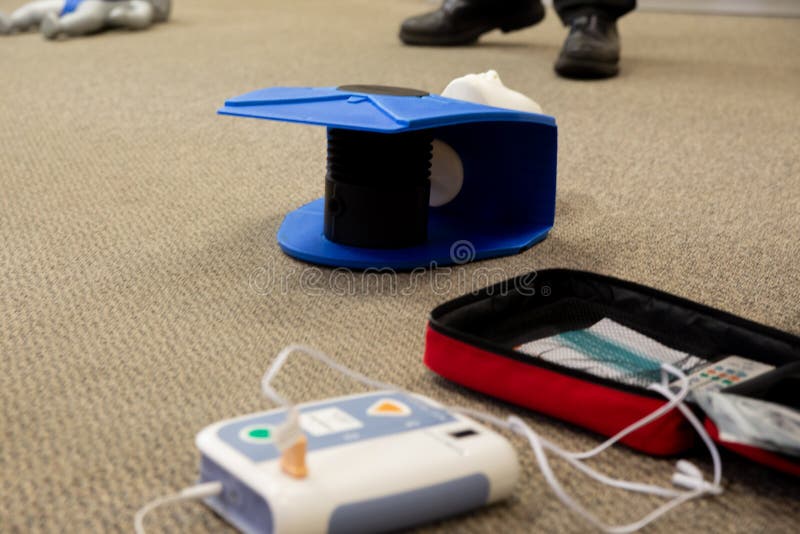 Staff Setting AED Machine To Practice First Aid Stock Photo - Image of ...