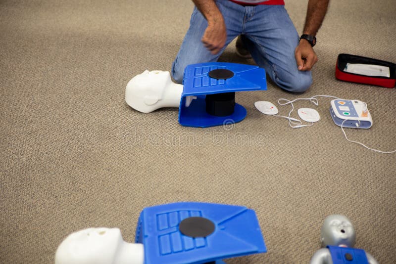 Staff Setting AED Machine To Practice First Aid Stock Photo - Image of ...