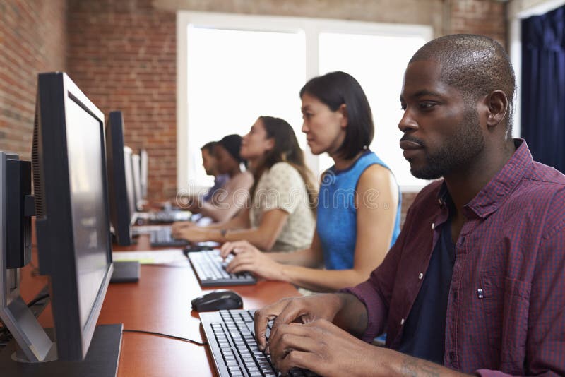Rear View of Staff at Desks Using Computers in Busy Office Stock Photo ...