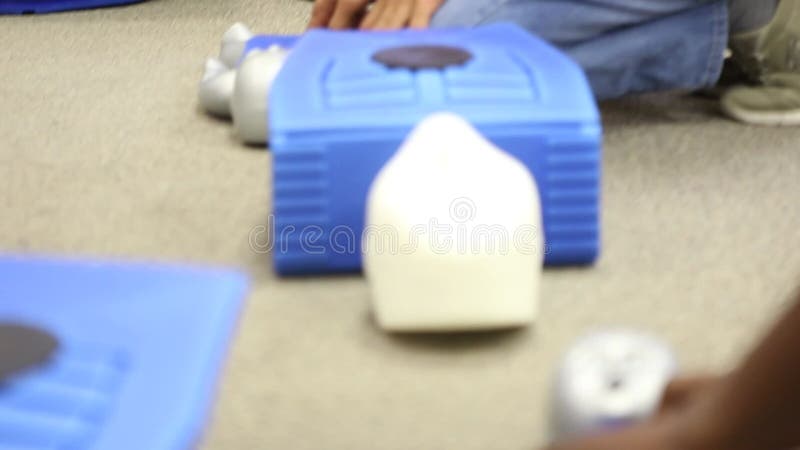 Staff Practicing First Aid Cpr with AED Machine and Dummy Dolls Stock ...
