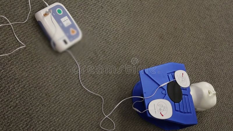 Staff Practicing First Aid Cpr with AED Machine and Dummy Dolls Stock ...