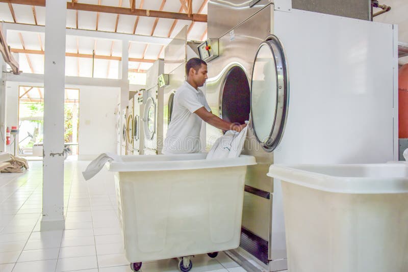 Staff in Uniform Cleaning Bed Sheets in Washing Machine Editorial Image ...