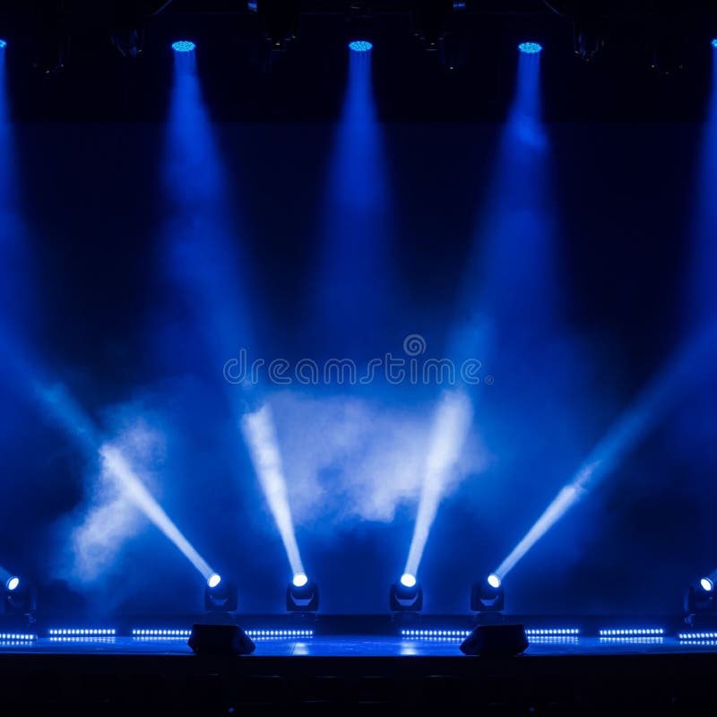 Stage Illuminated by Multiple Blue Spotlights, Creating Beams of Light ...