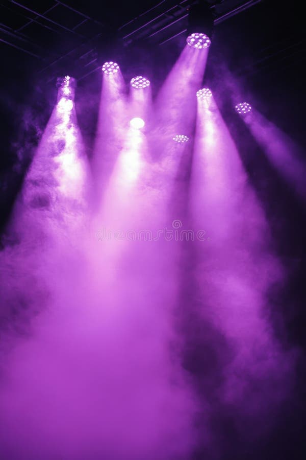 Dramatic Purple Lighting Fills a Stage with Mist during a Theatrical ...