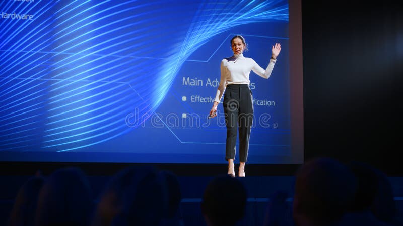 On-Stage Successful Female Speaker Presents Technological Product, Uses ...
