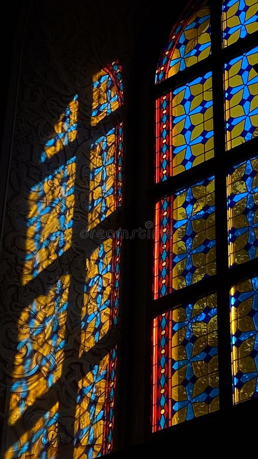 Stained Glass Window with Blue and Yellow Pattern Casting Shadows Stock ...