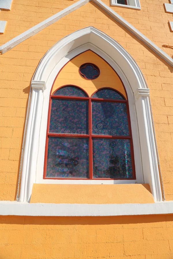 A Photograph of the Window Frames on an Orange Church with White Trim ...