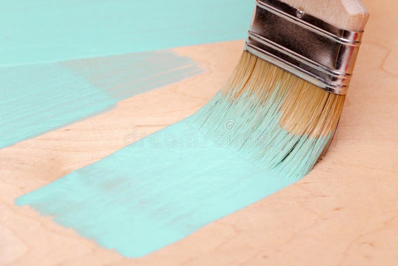 Staining the Wooden Surface of Turquoise Paint Using a Paint Brush ...
