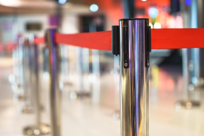 Stainless Barricade with Red Rope on a Blurred Interior Background ...