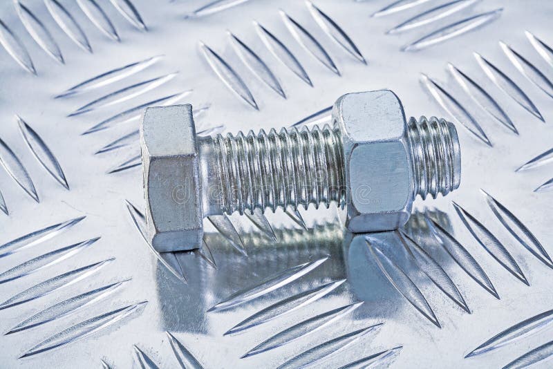 Stainless Bolt and Threaded Nut on Grooved Metal Plate Construct Stock ...