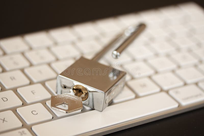 Stainless Padlock with Key in Front of Computer Keyboard. PC Network ...