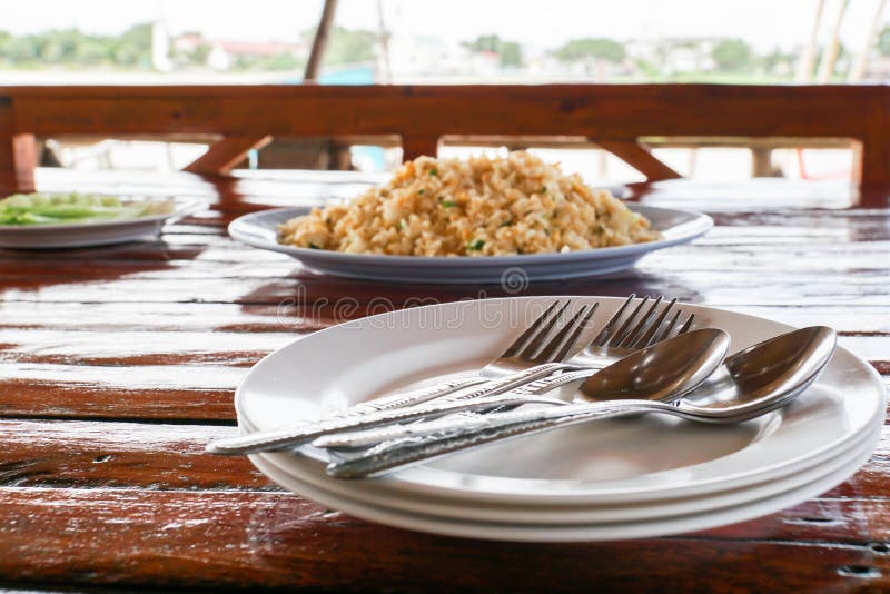 Stainless Spoon and Fork on White Plates on Wooden Table with Fried ...