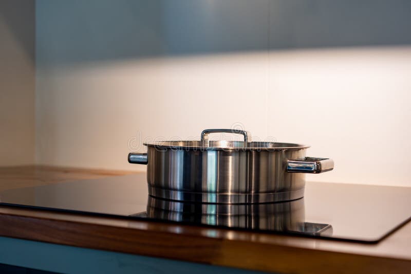 Stainless Steel Pot on Electronic Modern Flat Stove in Low Light on ...