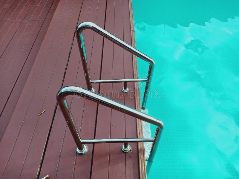Stainless Steel Railing into the Emerald Pool with a Wooden Edge Around ...