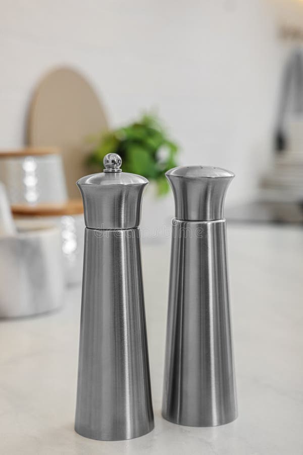 Stainless Steel Salt and Pepper Shakers on Table Stock Image - Image of ...