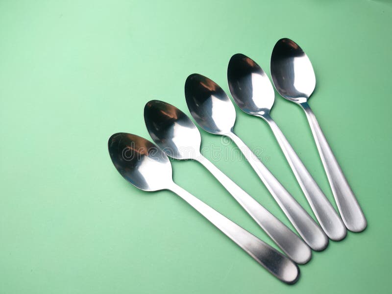 Stainless Steel Spoon Arranged on a Green Stock Image - Image of ...