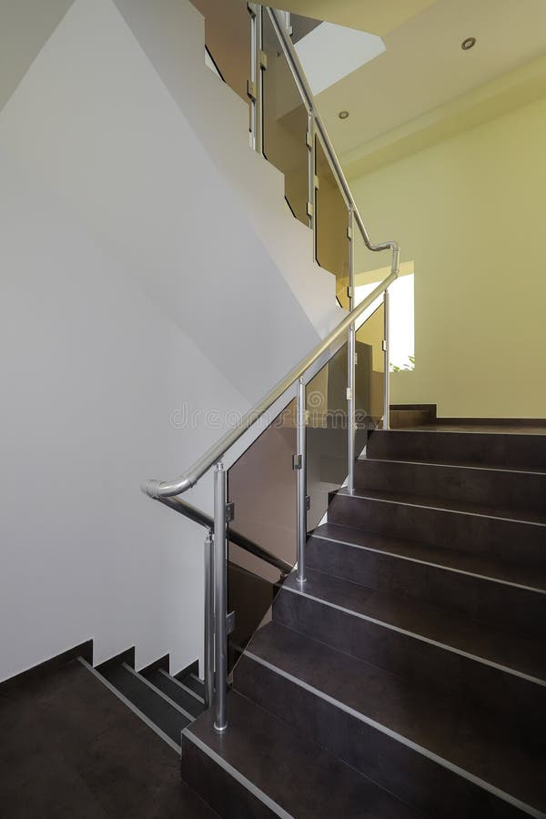 Staircase with Brown Tiles and Light Walls Inside the House Stock Photo ...