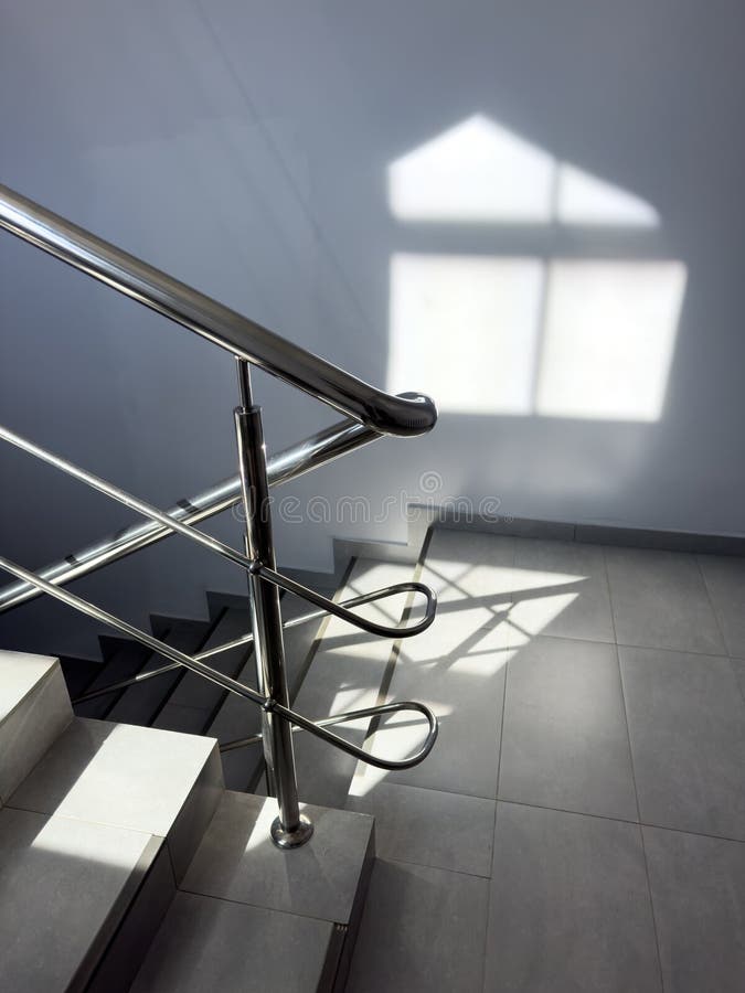 A Staircase with a Metal Railing and a Shadow on the Floor Stock Image ...