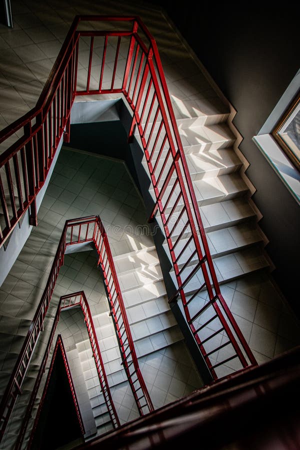 Staircase with Red Railing Spiraling Down Stock Image - Image of ...