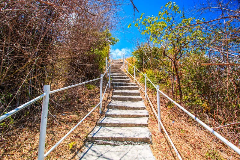 Uphill Concrete Sidewalk Walkway with Metal Railing and Greenery Stock ...