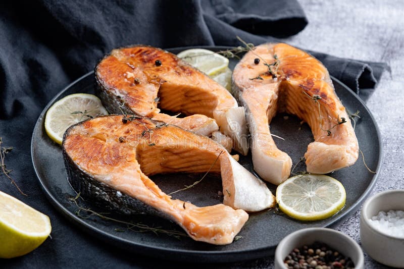 Stake Fish Trout with Lemon and Spices on Dark Background Stock Image ...