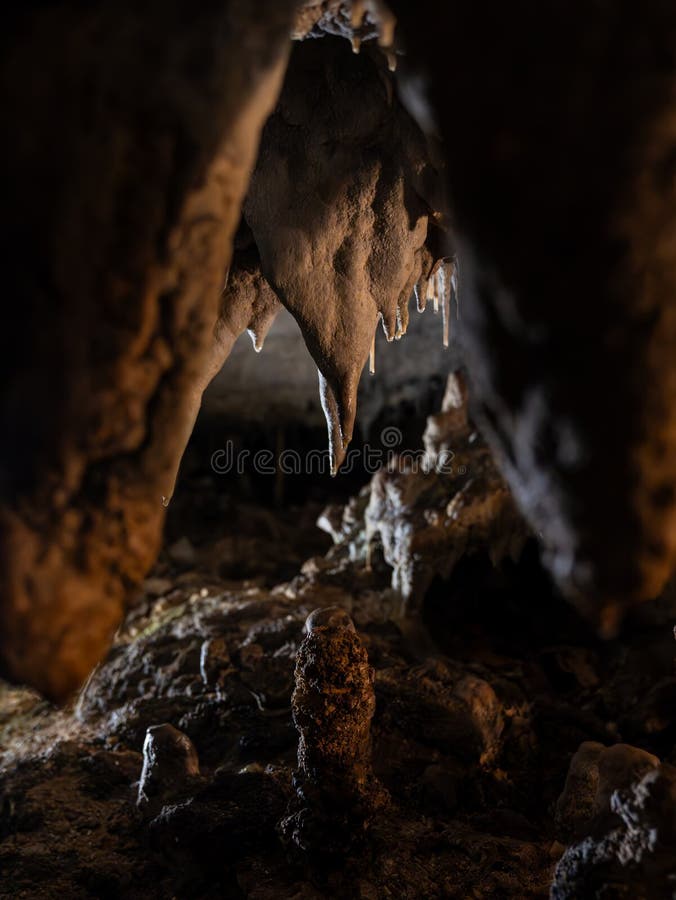 Stalactite Forming on Cave Ceiling with Stalagmites Growing from the ...